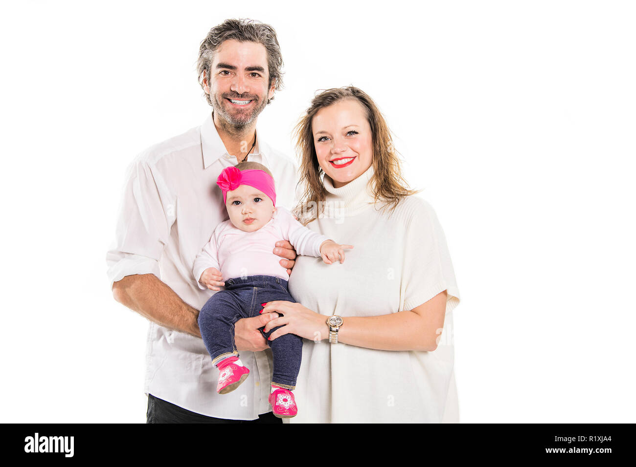A father, mother holding cute baby girl over white background Stock ...