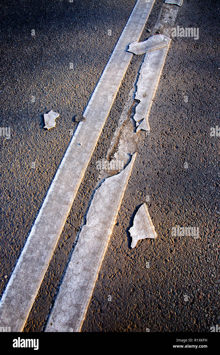 Brocken line of an asphalt road marking close-up Stock Photo - Alamy