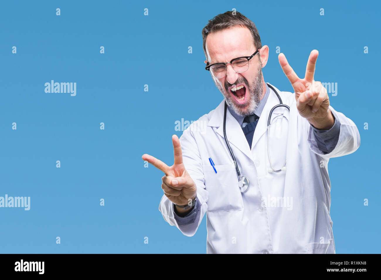 Middle age senior hoary doctor man wearing medical uniform isolated ...