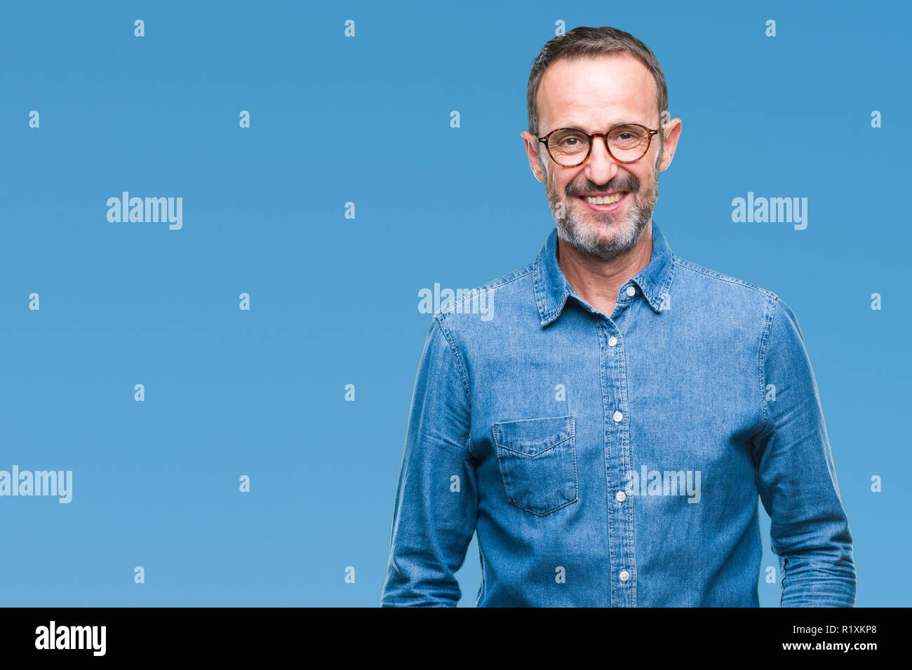 Middle age hoary senior man wearing glasses over isolated background ...