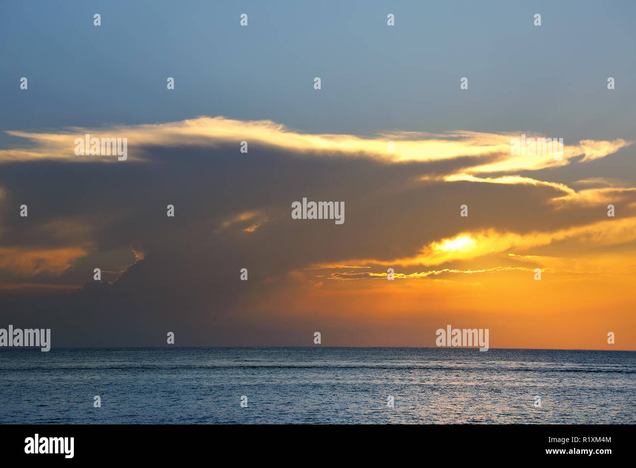 Colorful empty seascape with shiny sea over cloudy sky and sun during ...