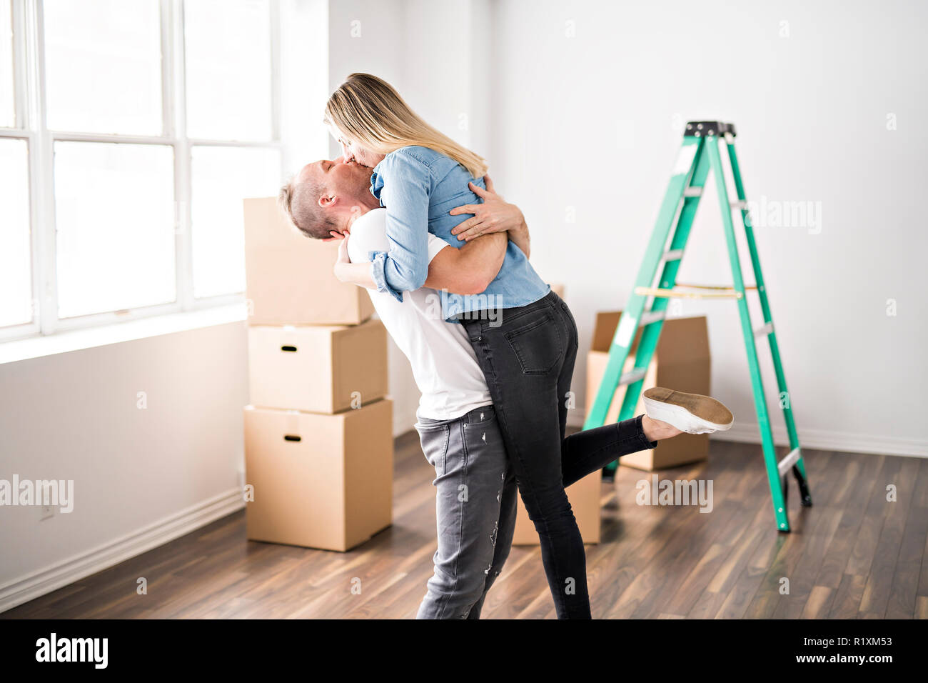 loving Couple moving from house at day time Stock Photo - Alamy