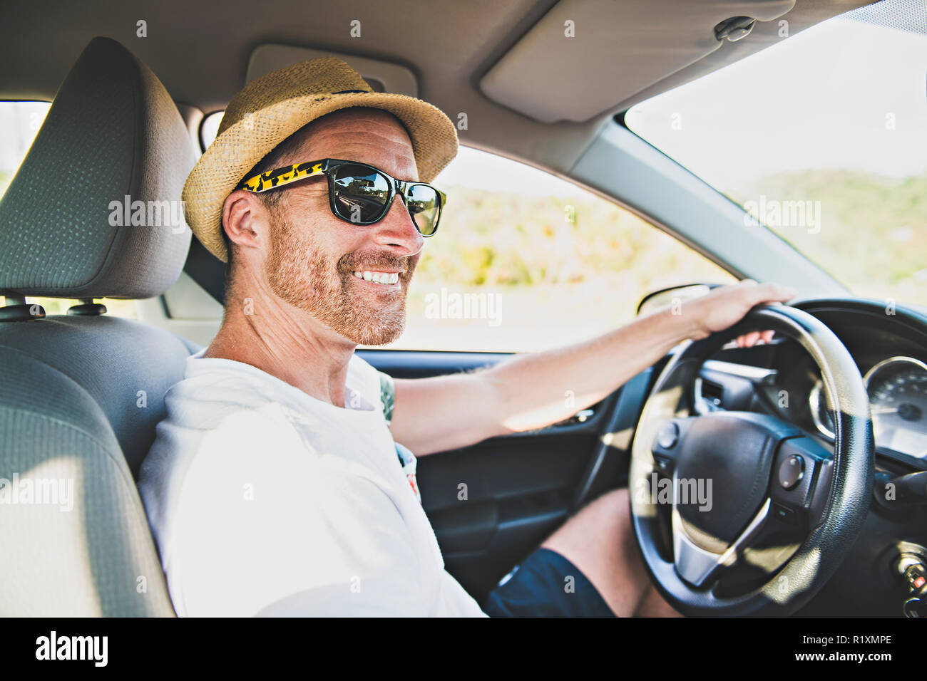 A men sitting in a rental car on holiday vacancy Stock Photo - Alamy