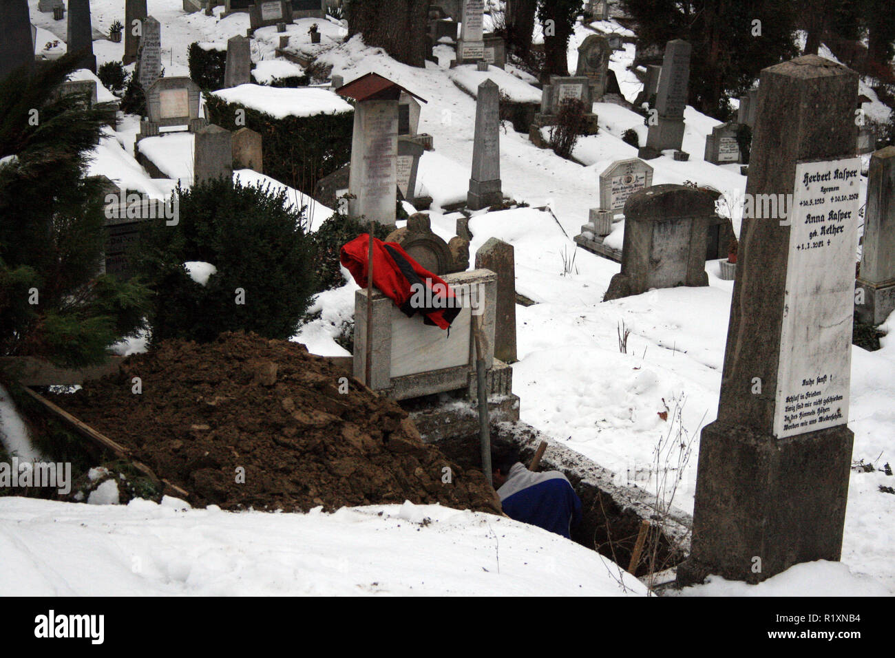Digging a grave in snowy Church on the Hill Cemetery in Sighisoara ...