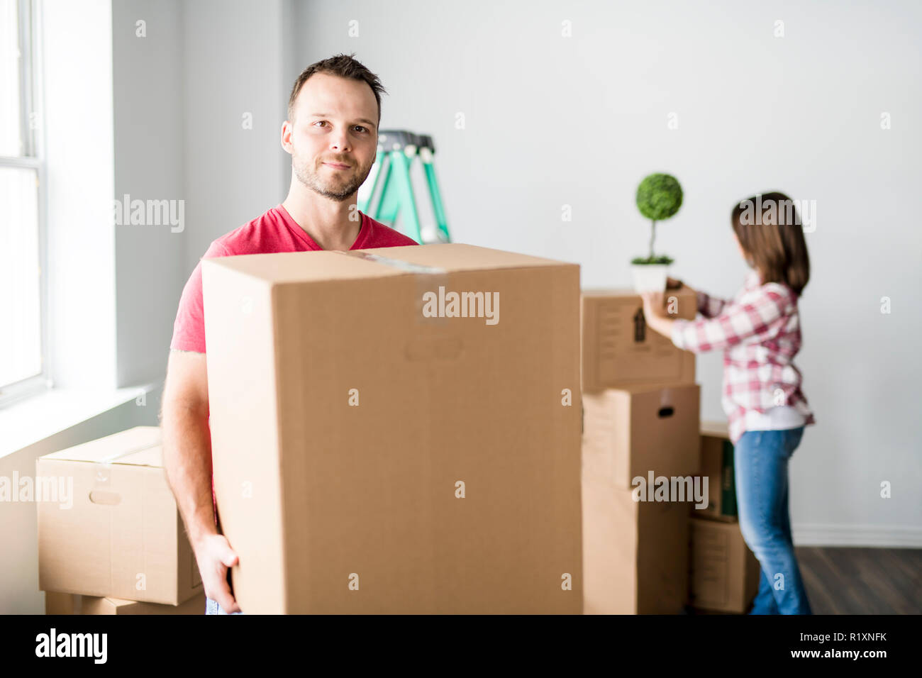 Loving Couple moving from house at day time Stock Photo - Alamy