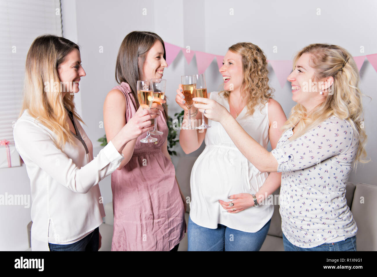 A Portrait of happy friends having a toast at baby shower Stock Photo ...