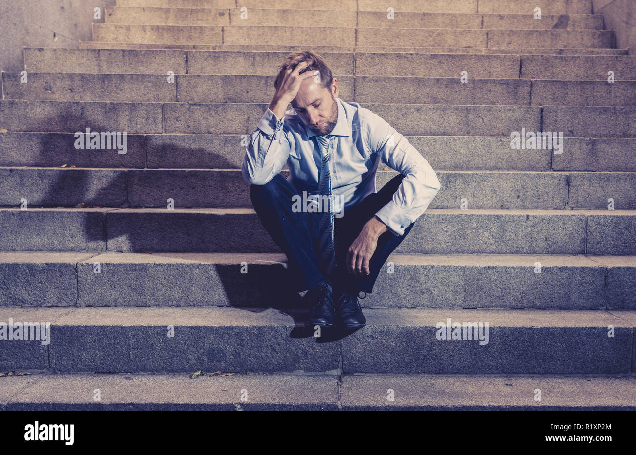 Young fired business man lost in depression crying abandoned sitting on ...