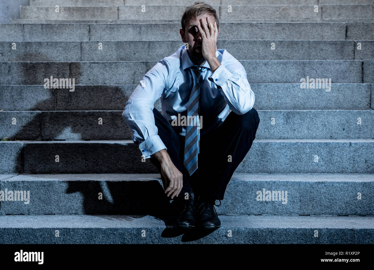 Young fired business man lost in depression crying abandoned sitting on ...