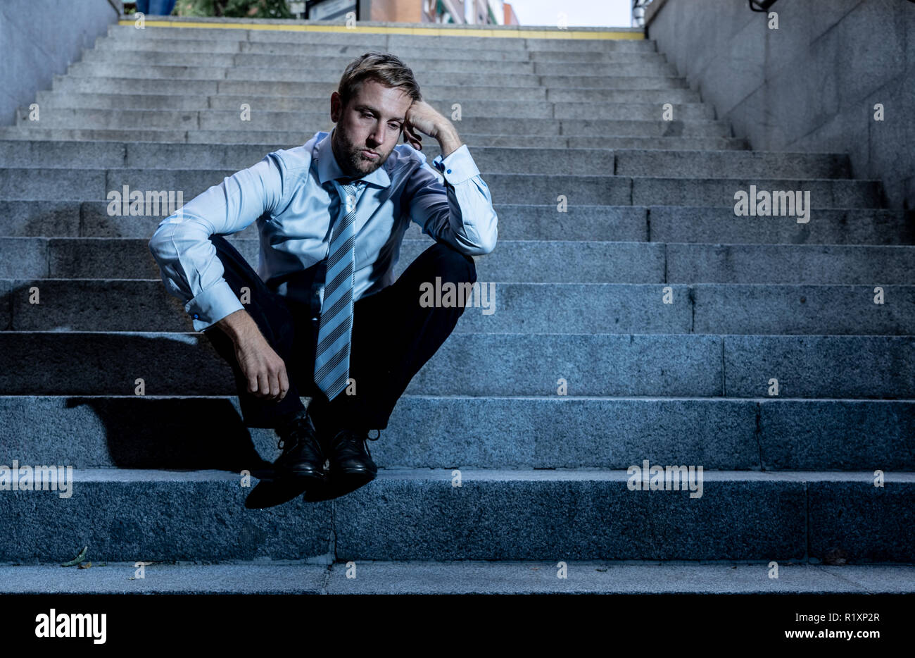 Young fired business man lost in depression crying abandoned sitting on ...