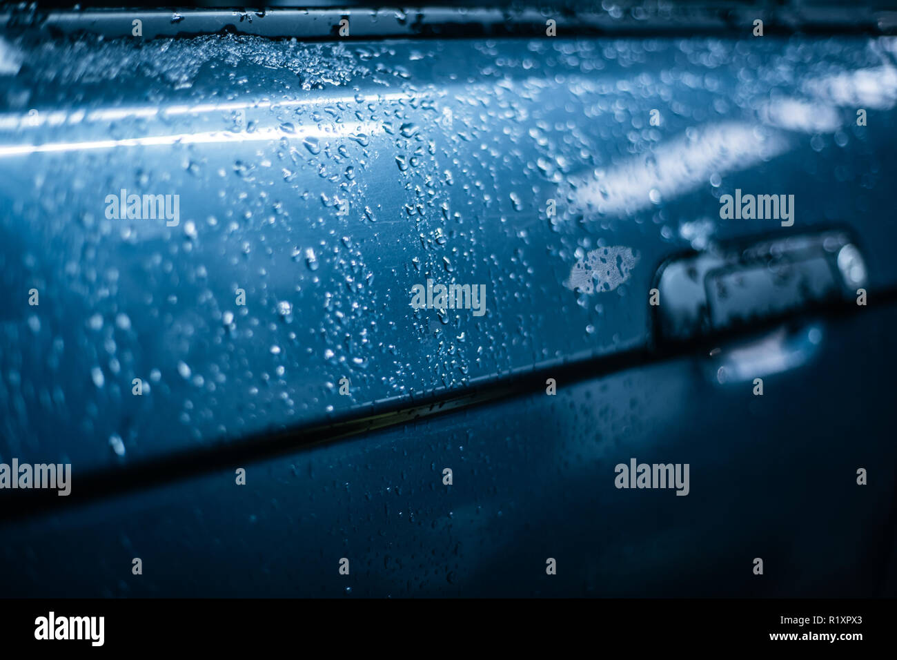 Water drops on the surface of a blue car in cold colors Stock Photo - Alamy