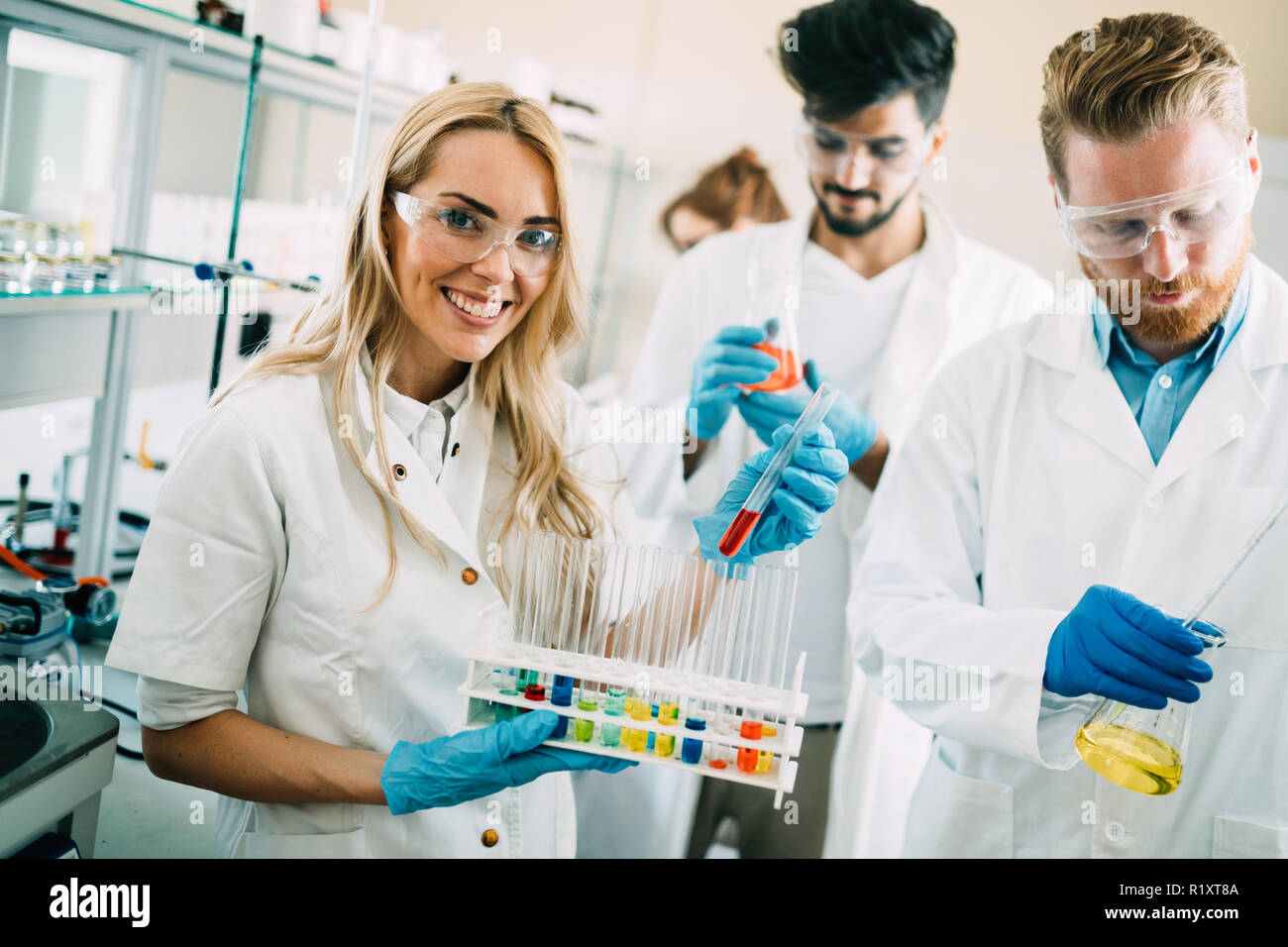 Group of chemistry students working in laboratory Stock Photo - Alamy