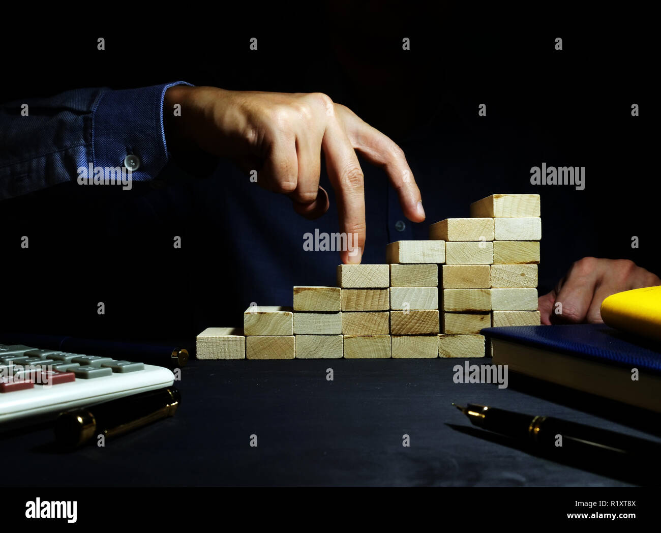 Career path. Stairs from wooden blocks and man Stock Photo - Alamy