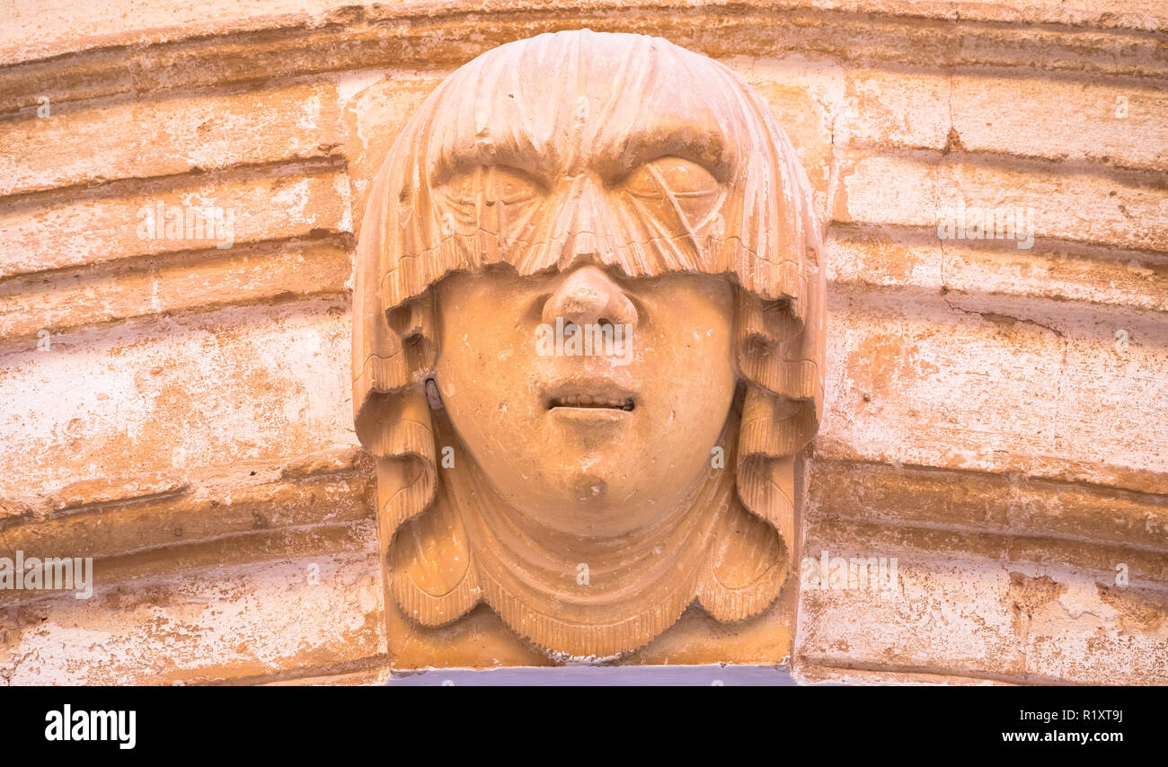 Gothic detail. Young woman portrait at the entrance of a 200 years old ...