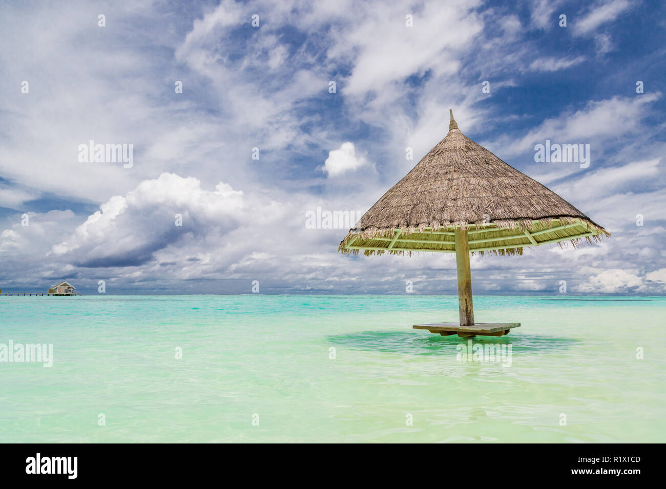 Parasol beach on the coast. White sand and blue water of the sea ...