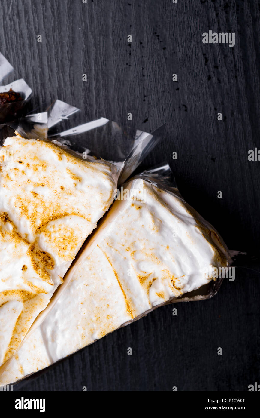 Top view image on two pieces of coconut pie isolated cut on wooden ...