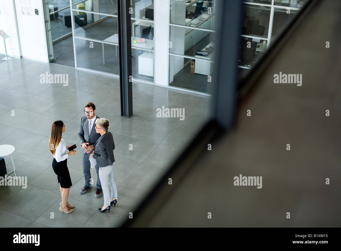 Colleagues discuss project plans in hi-res stock photography and images ...