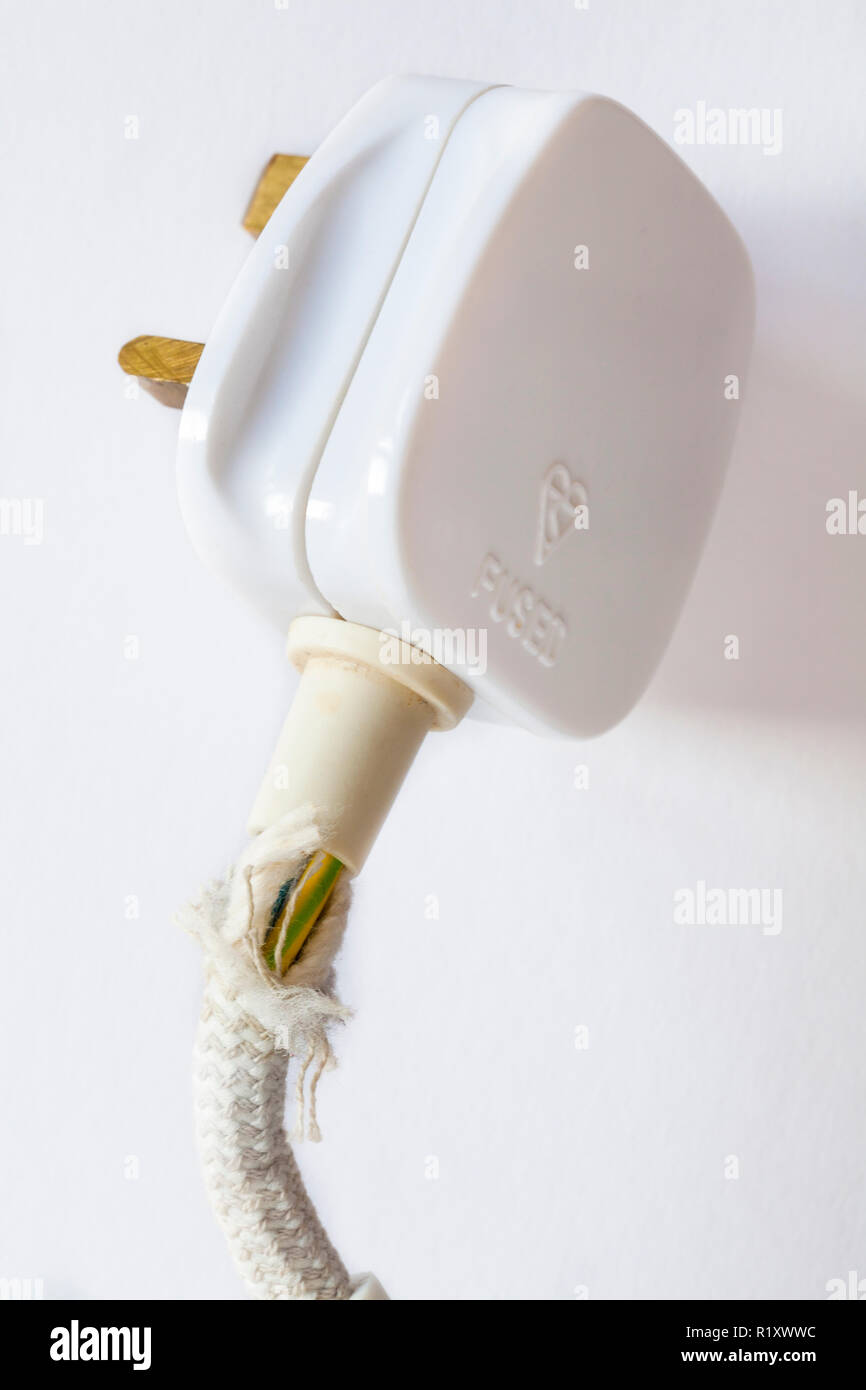Old dusty 3 pin electrical UK plug with damaged frayed wiring set on ...