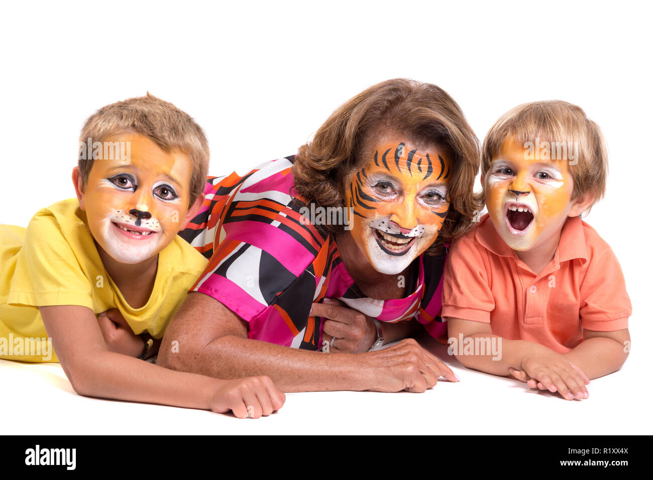 Children's group and grandmother all with animal face-paint isolated in ...