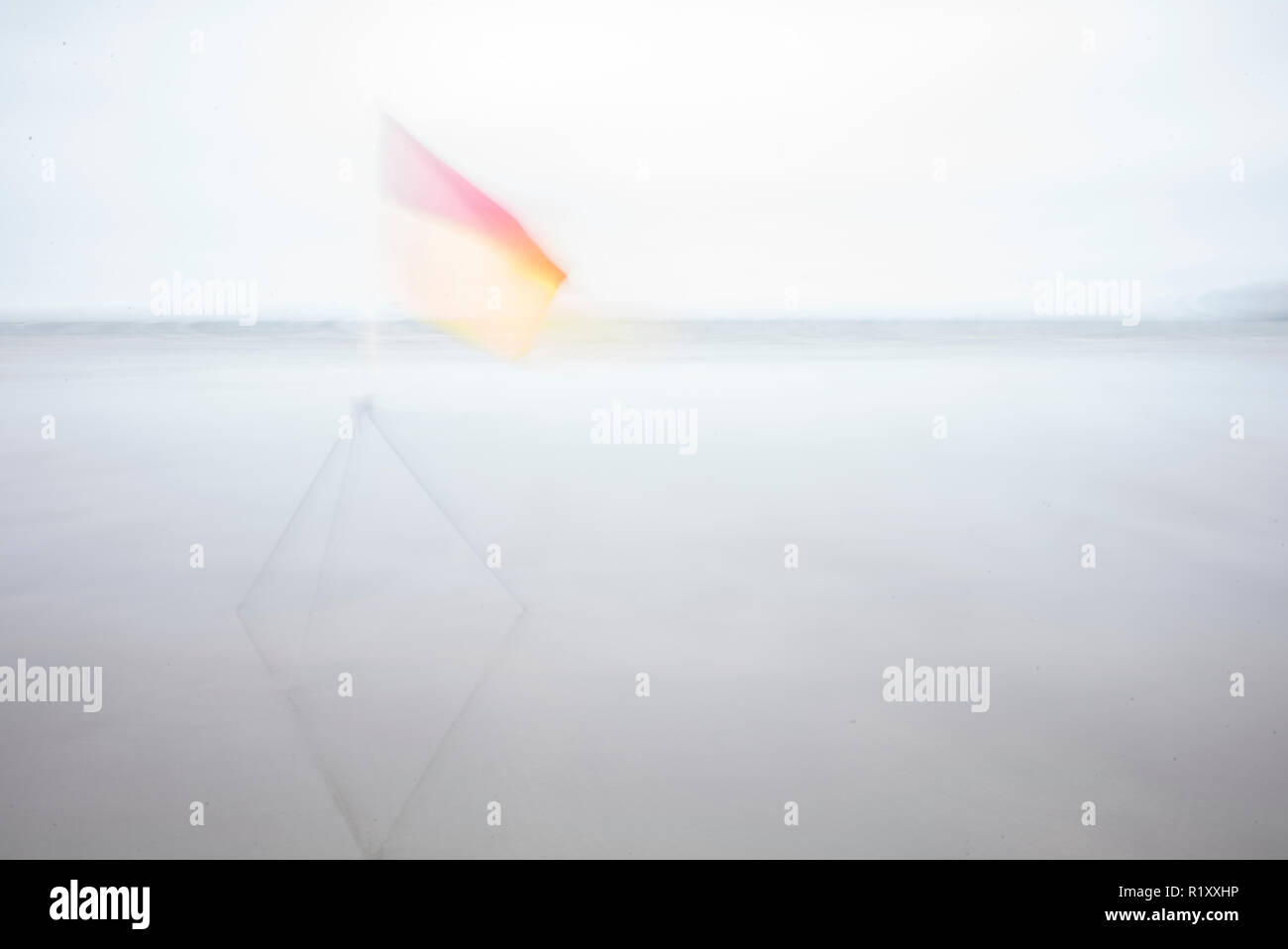 Safety red and orange flags on a beach Stock Photo - Alamy