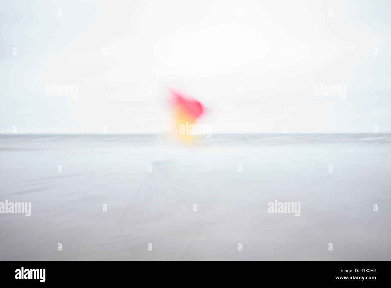 Safety red and orange flags on a beach Stock Photo - Alamy