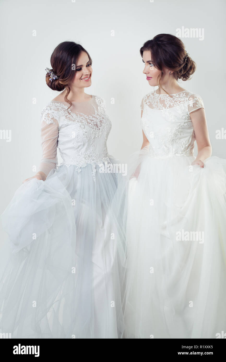 Smiling young women in elegant white dress. Two bride Stock Photo - Alamy