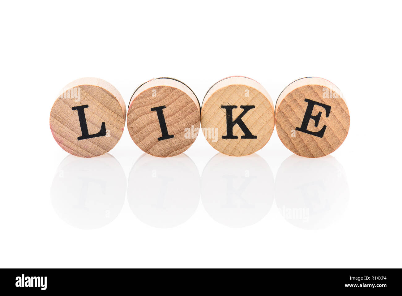 Word Like from circular wooden tiles with letters children toy. Concept ...