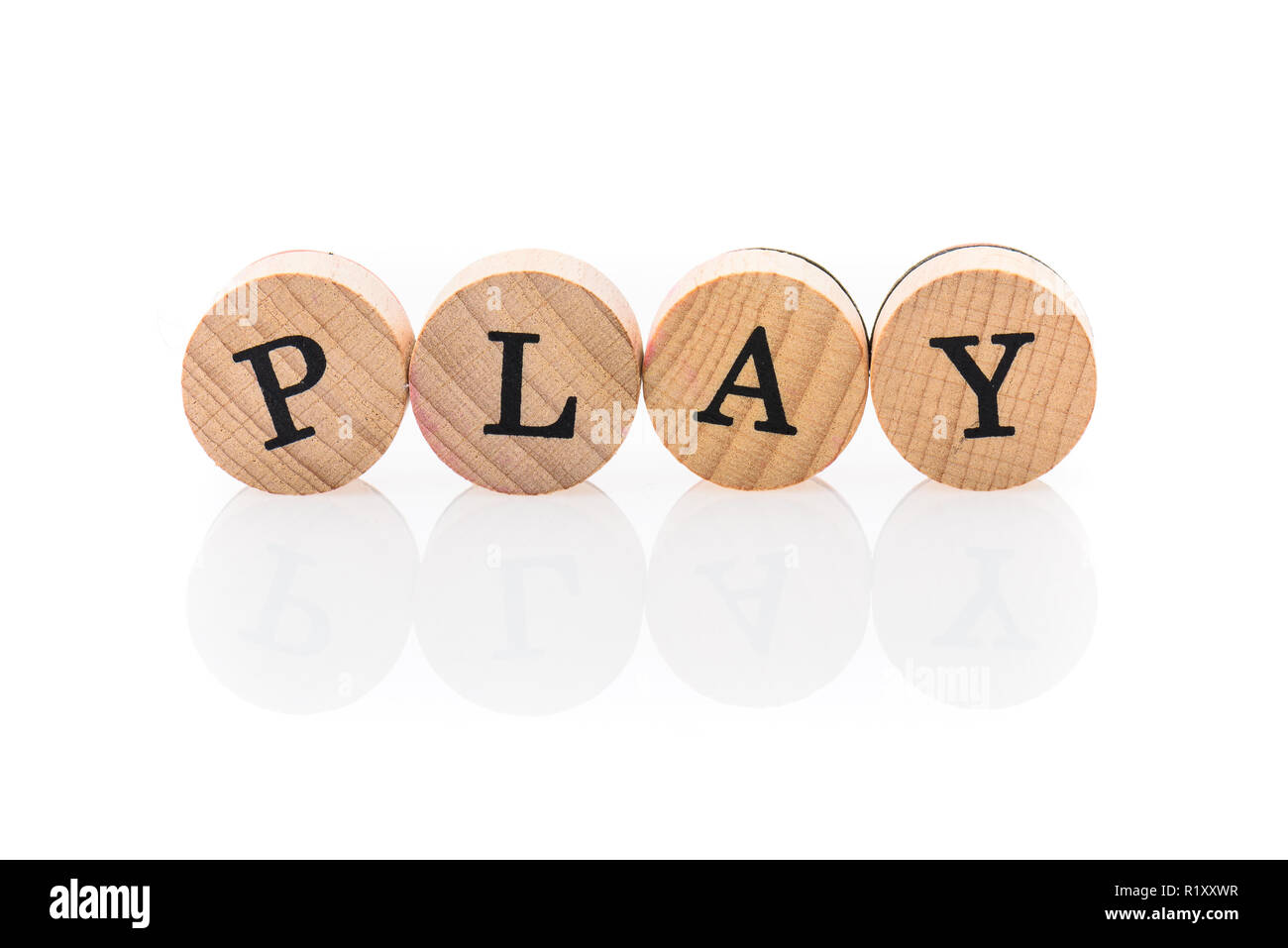 Word Play from circular wooden tiles with letters children toy. Concept ...