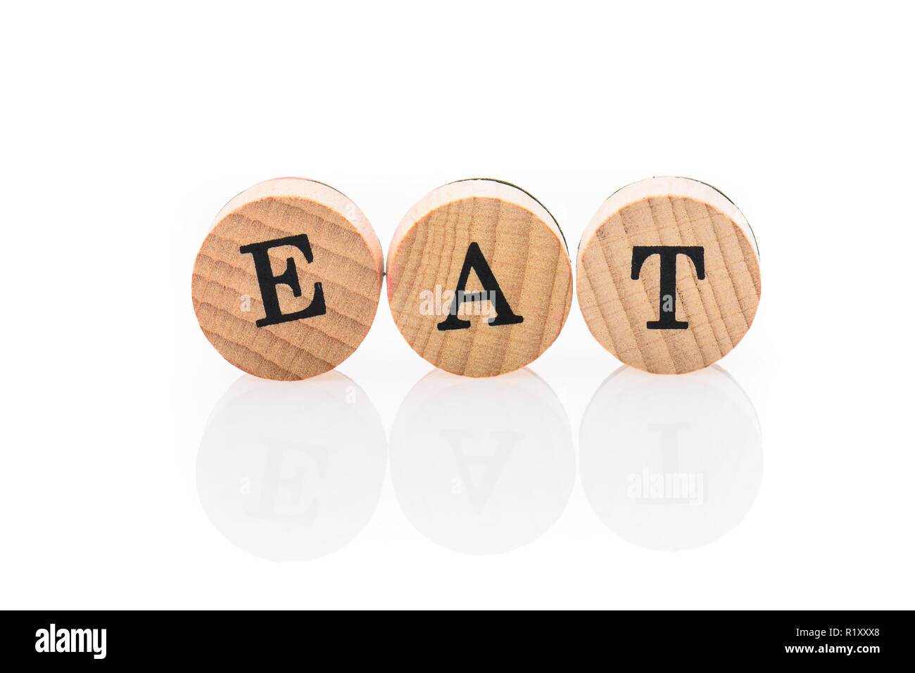 Word Eat from circular wooden tiles with letters children toy. Concept ...