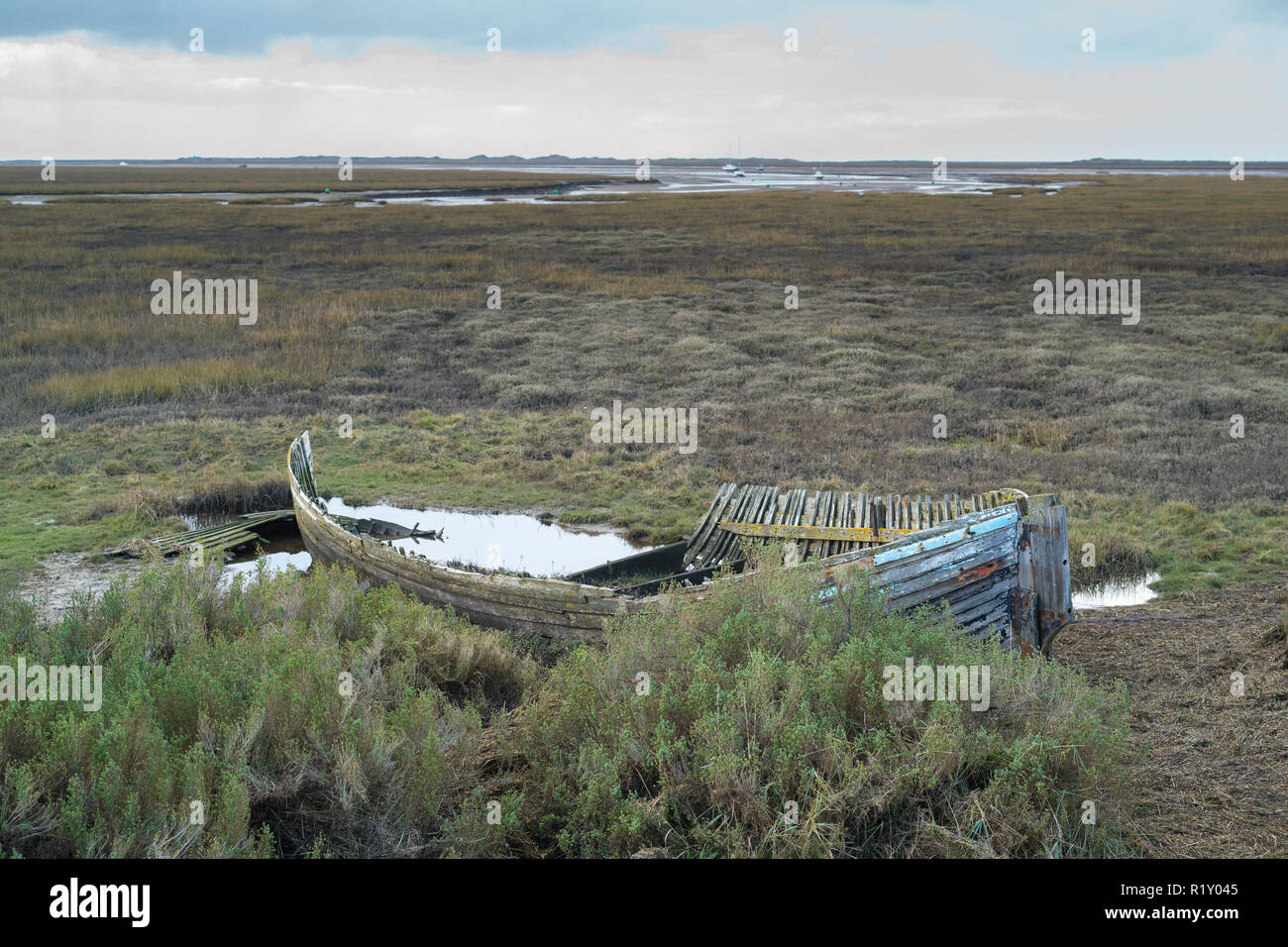 Abandoned derelict shabby sailing boat in marshland at Brancaster ...