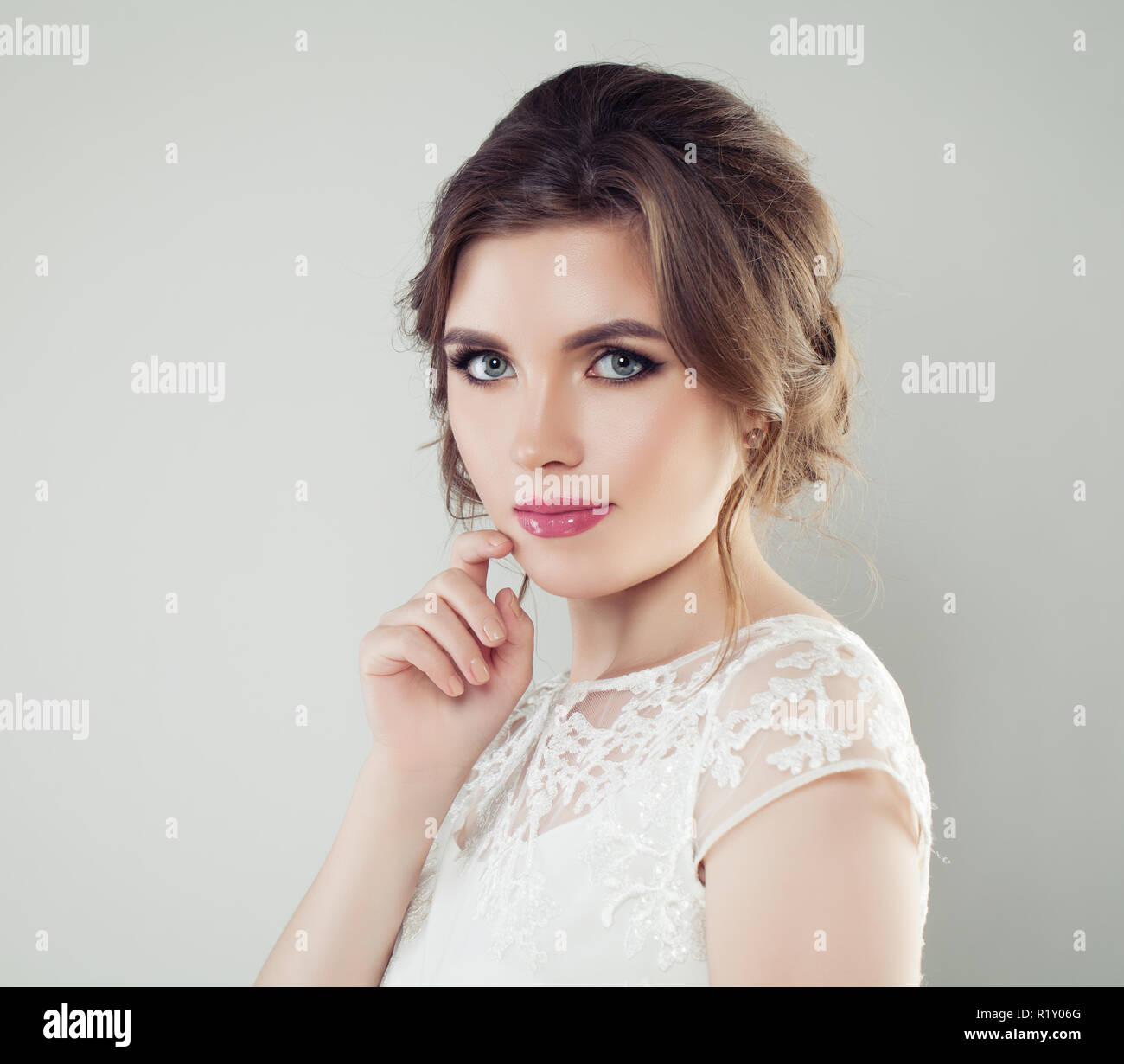 Beautiful young woman with makeup and bridal hairstyle. Pretty girl ...