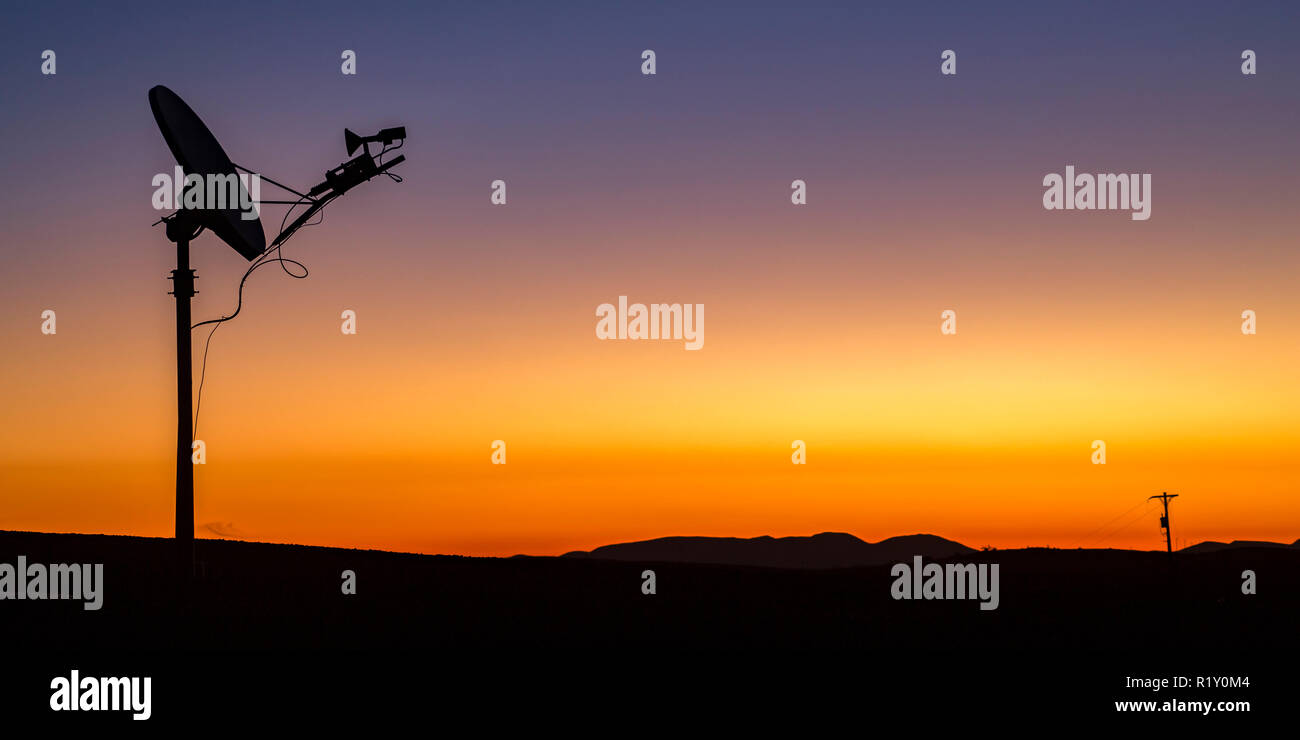 Silhouette of satellite and power line at sunset Stock Photo - Alamy
