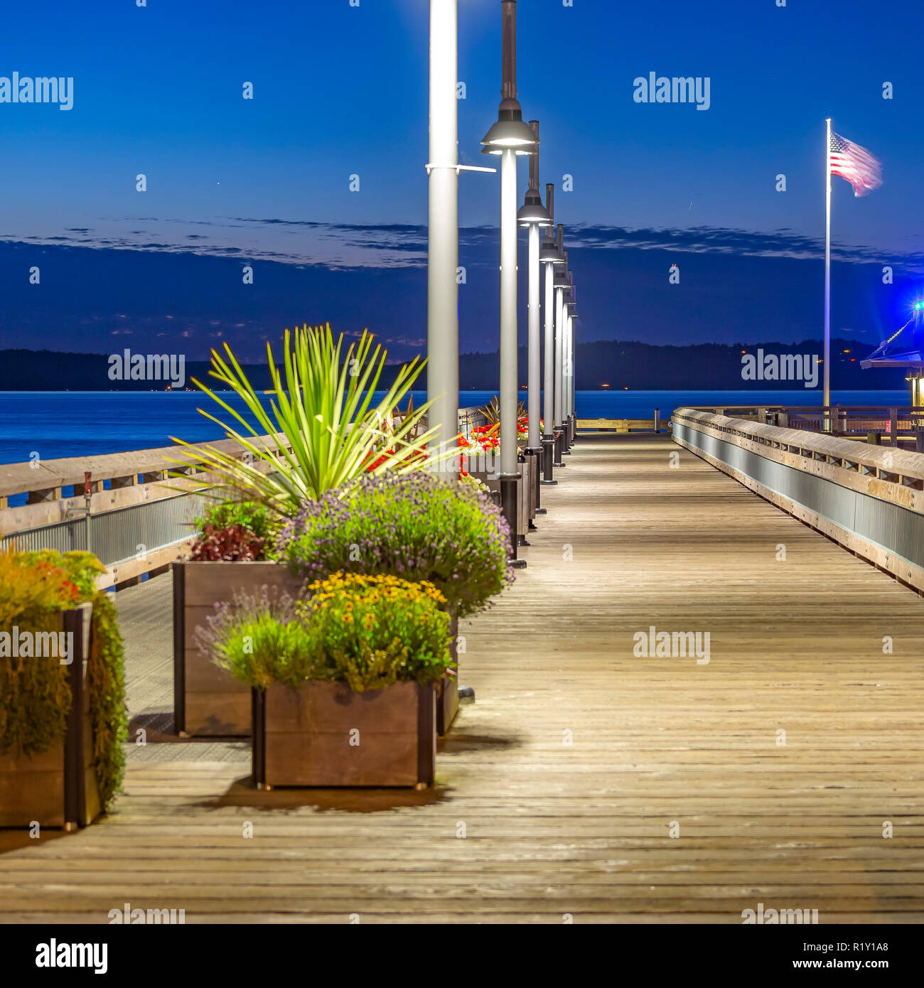 Tacoma pier at sunset with lamp posts and US flag Stock Photo - Alamy