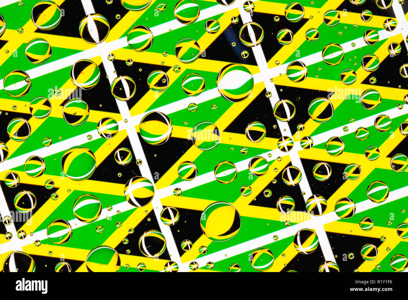 Flags of Jamaica, behind a glass covered with rain drops.Pattern from ...