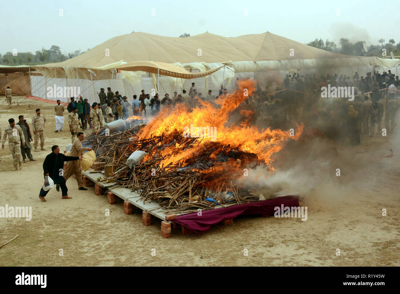 Lahore. 14th Nov, 2018. Anti Narcotics Force (ANF) officials burn a ...