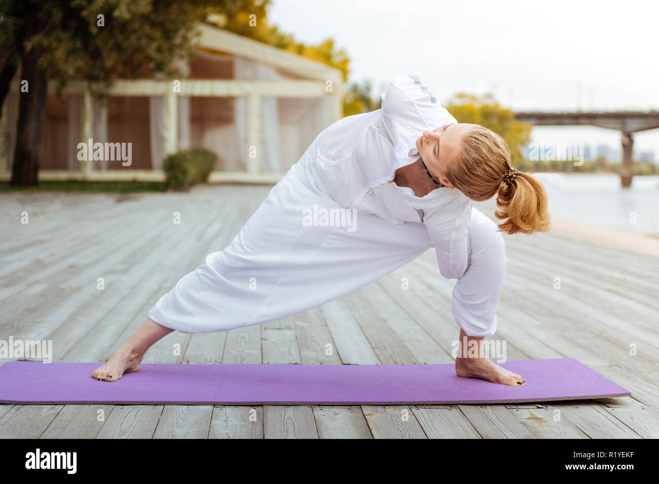 Female yogi stretching her muscles while doing exercises Stock Photo ...