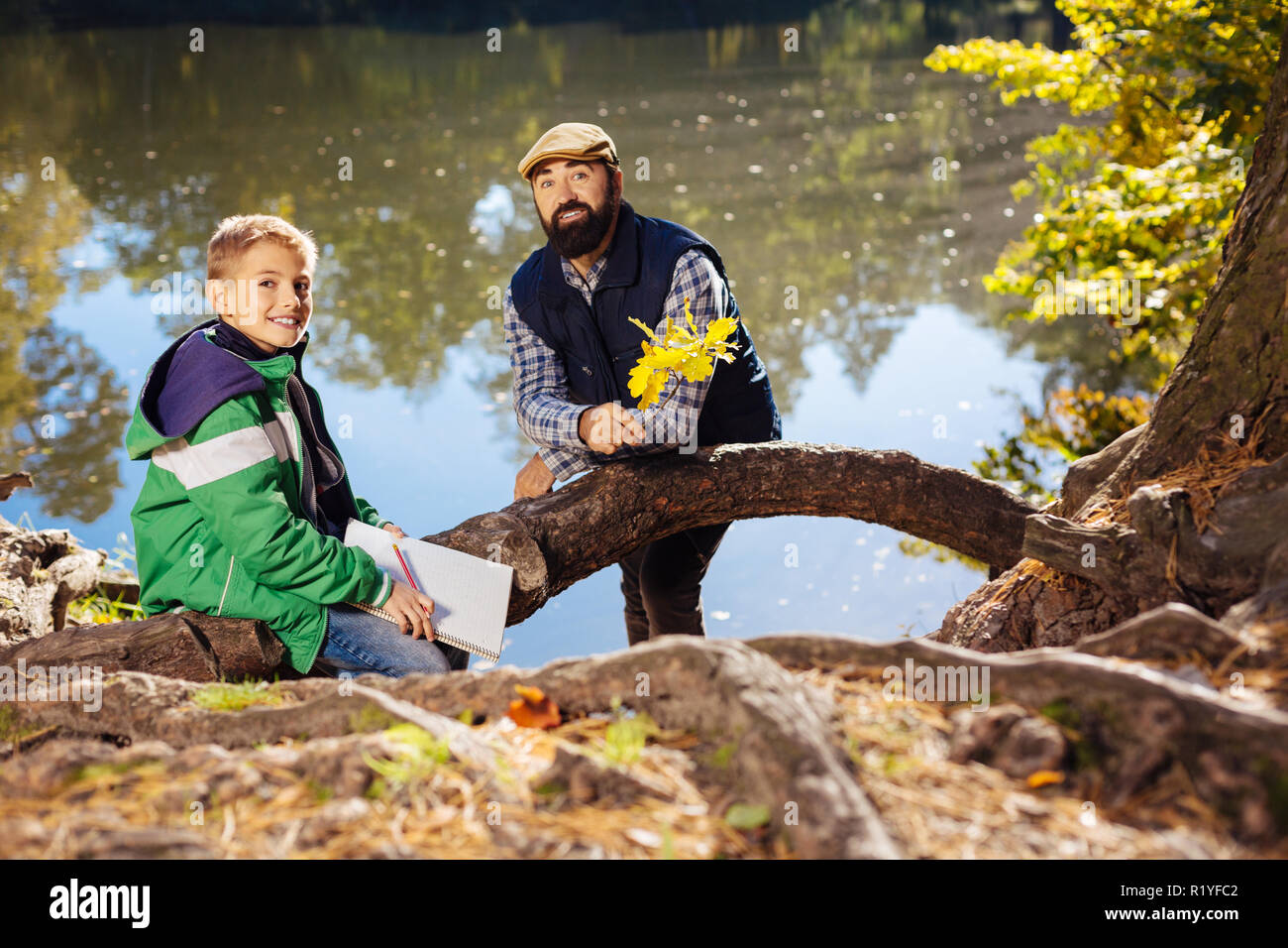 Happy nice father and son having a forest walk Stock Photo - Alamy