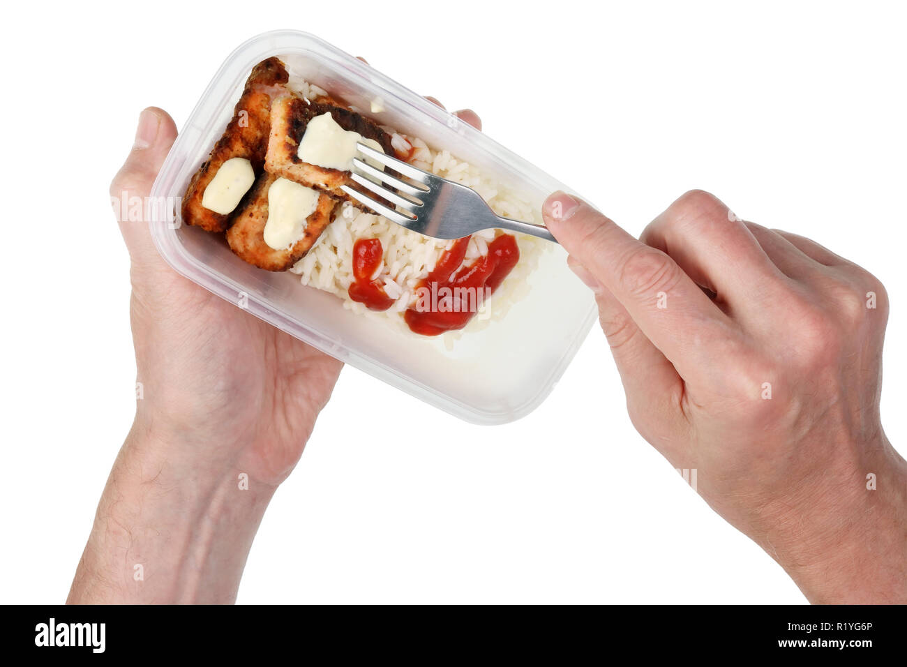 Poor elderly man eating fried fish with rice from a plastic container ...