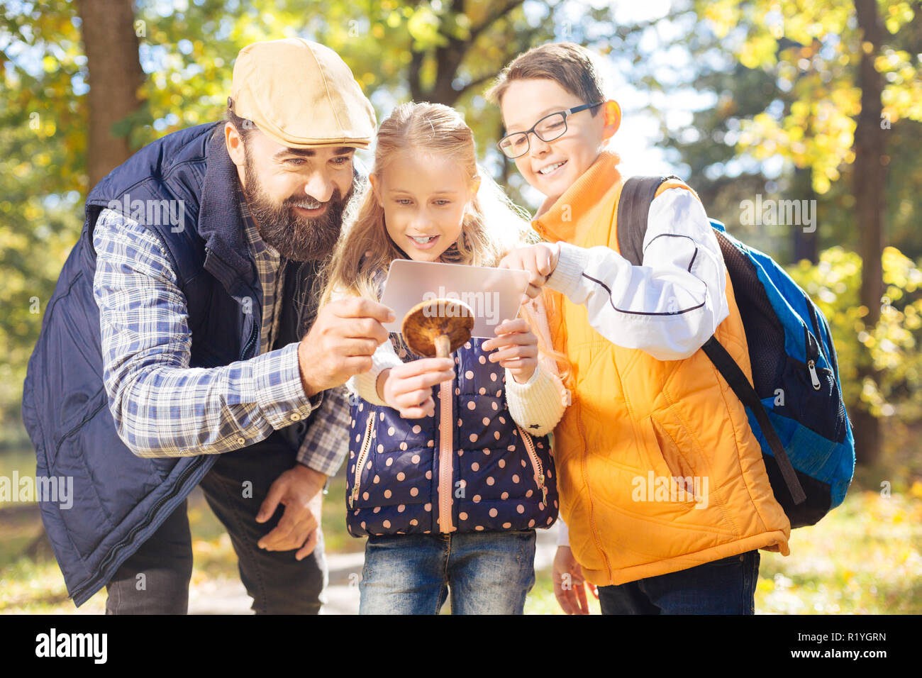 Delighted excited children taking photos of the mushroom Stock Photo ...