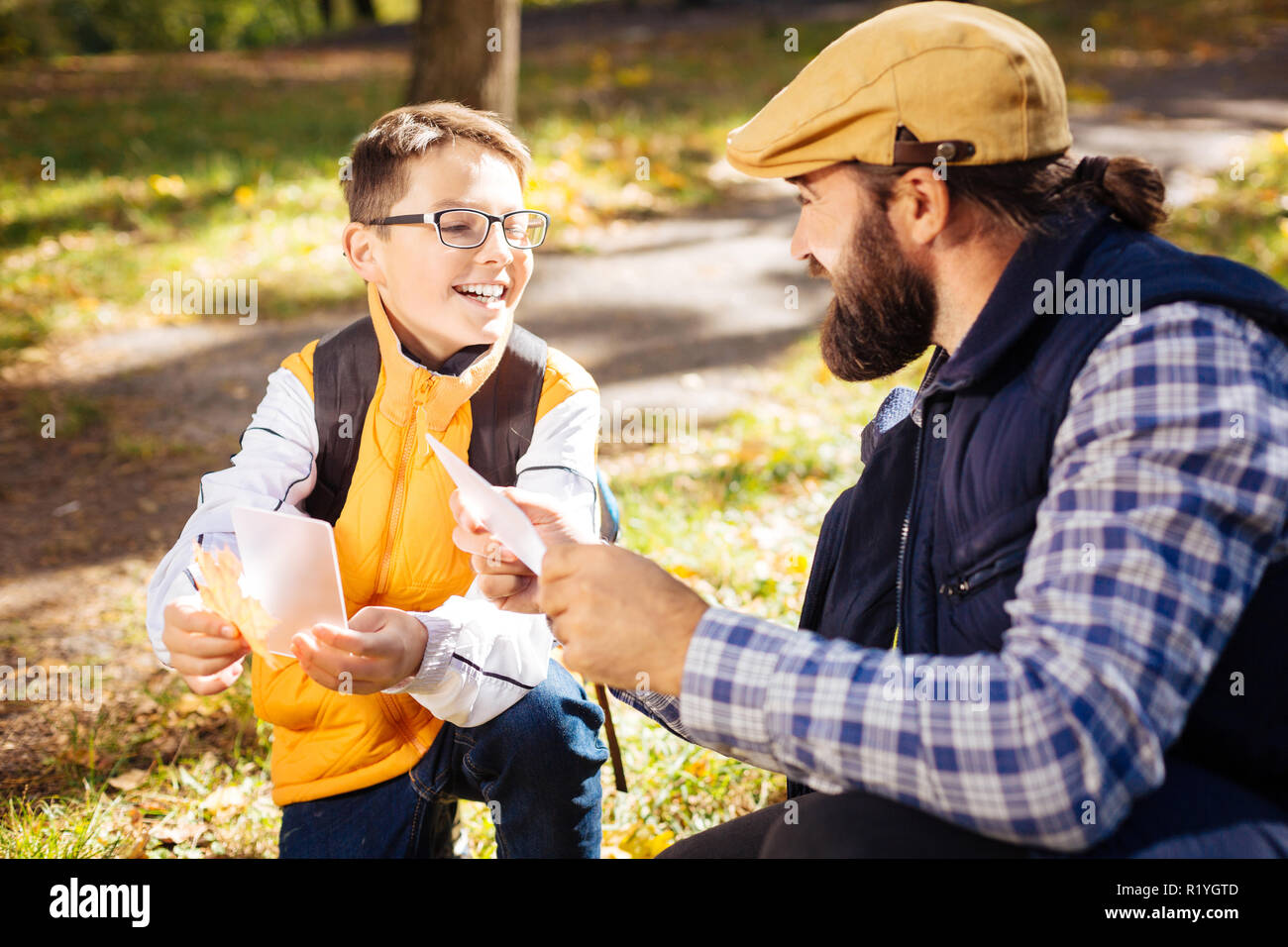 Positive joyful father and son using their gadgets Stock Photo - Alamy