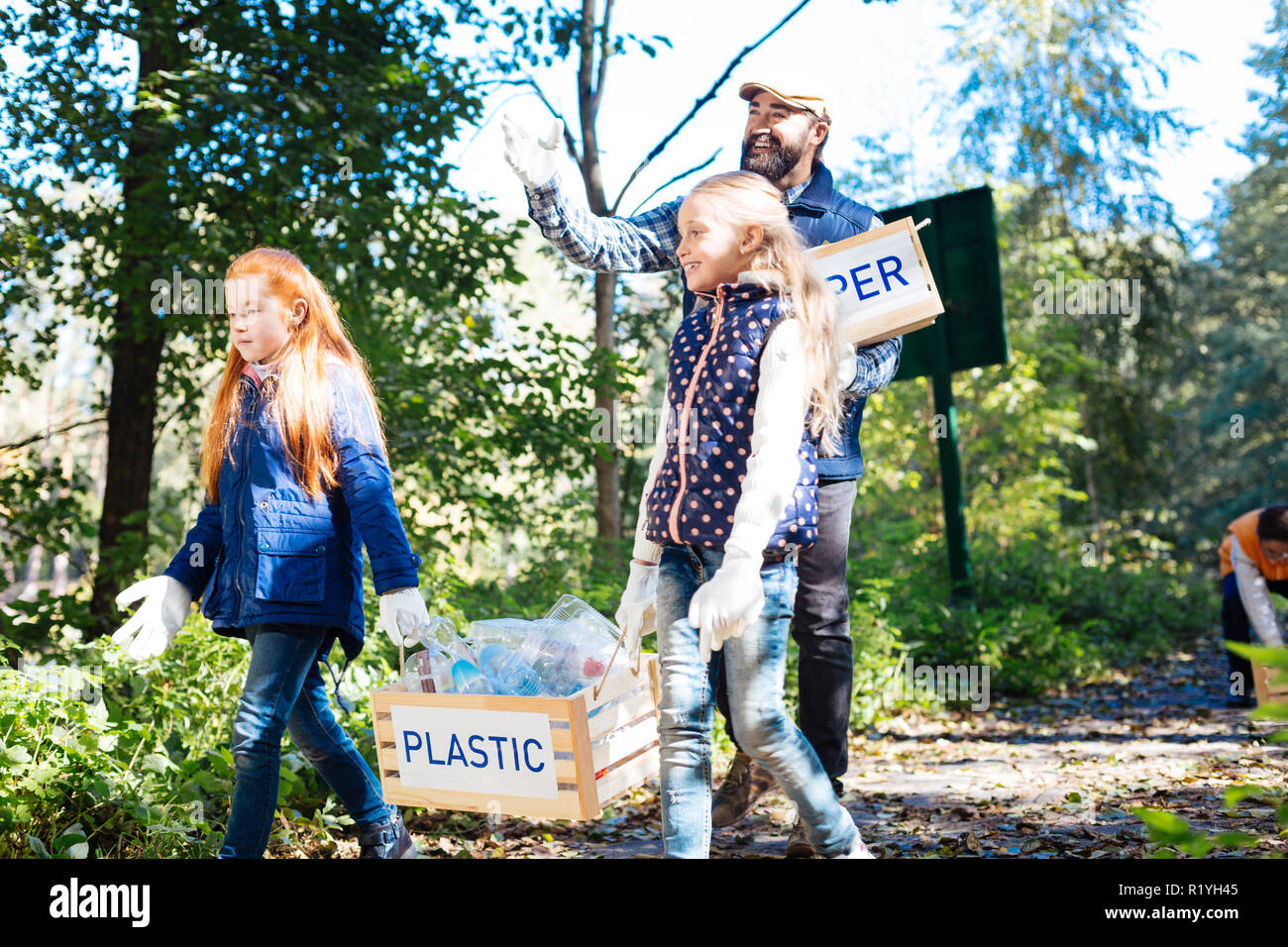 Cute young girls taking away plastic garbage Stock Photo - Alamy