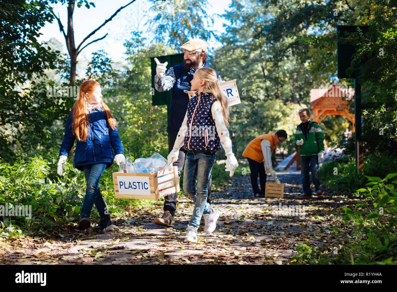 Pleasant nice girls carrying a box together Stock Photo - Alamy