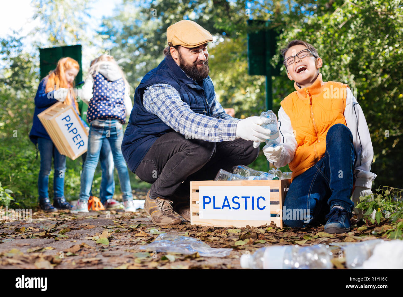 Positive nice young boy collecting plastic bottles Stock Photo - Alamy