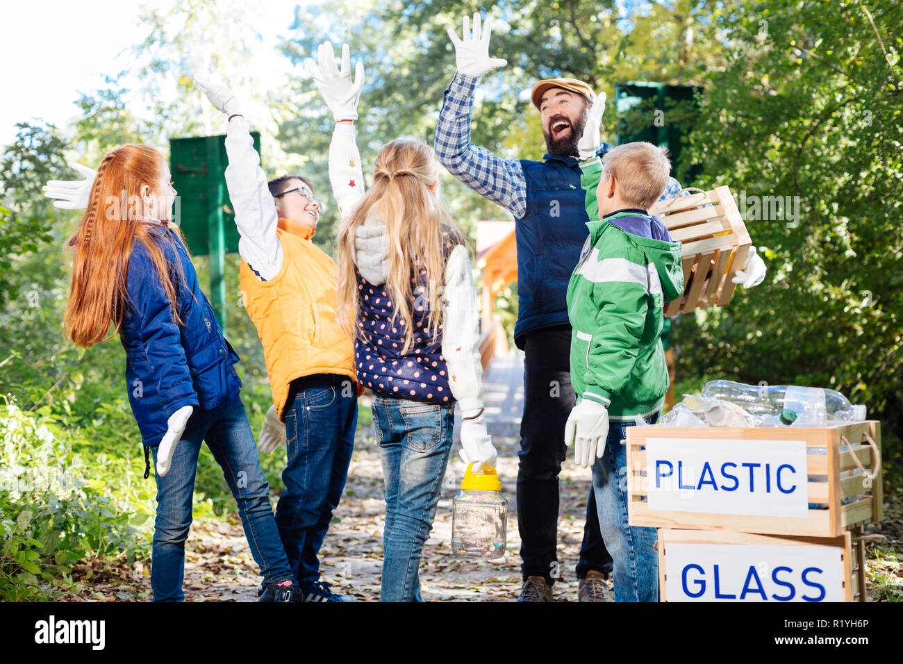 Happy delighted children giving high five to each other Stock Photo - Alamy