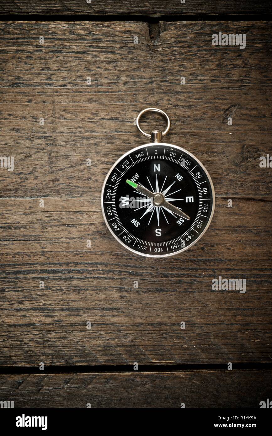 Vintage compass on a wood table Stock Photo - Alamy