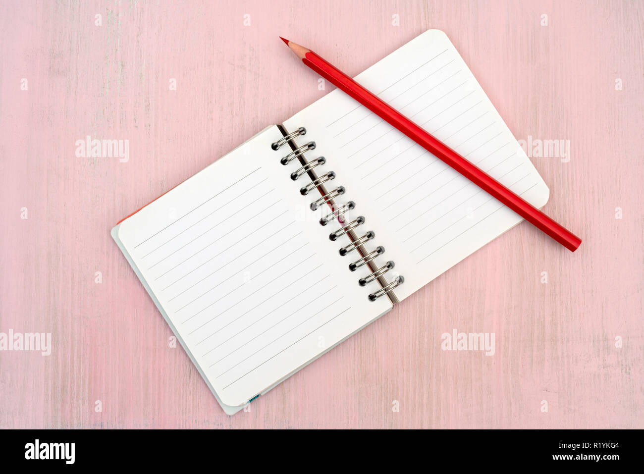 Red pencil and notebook for notes Stock Photo - Alamy
