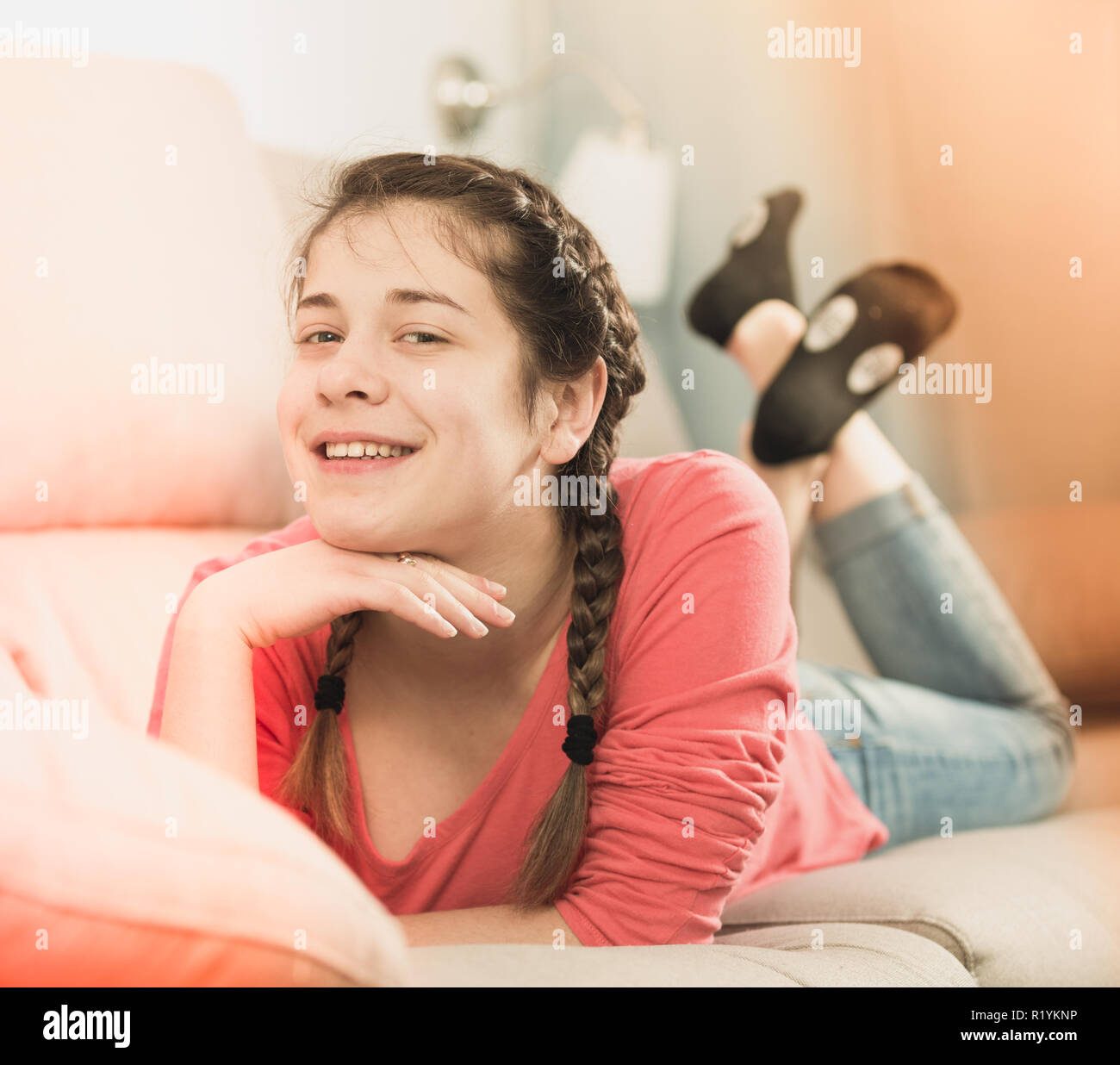 Smiling teenager using various poses having good time in leisure time ...
