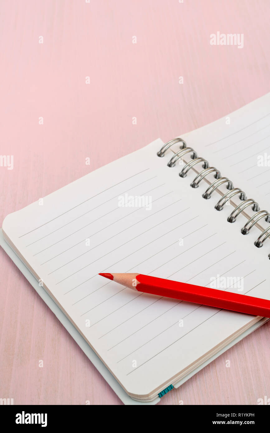 Red pencil and notebook for notes Stock Photo - Alamy