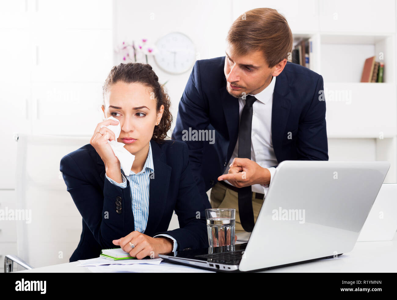 Crying subordinate woman being punished to making mistake by man ...