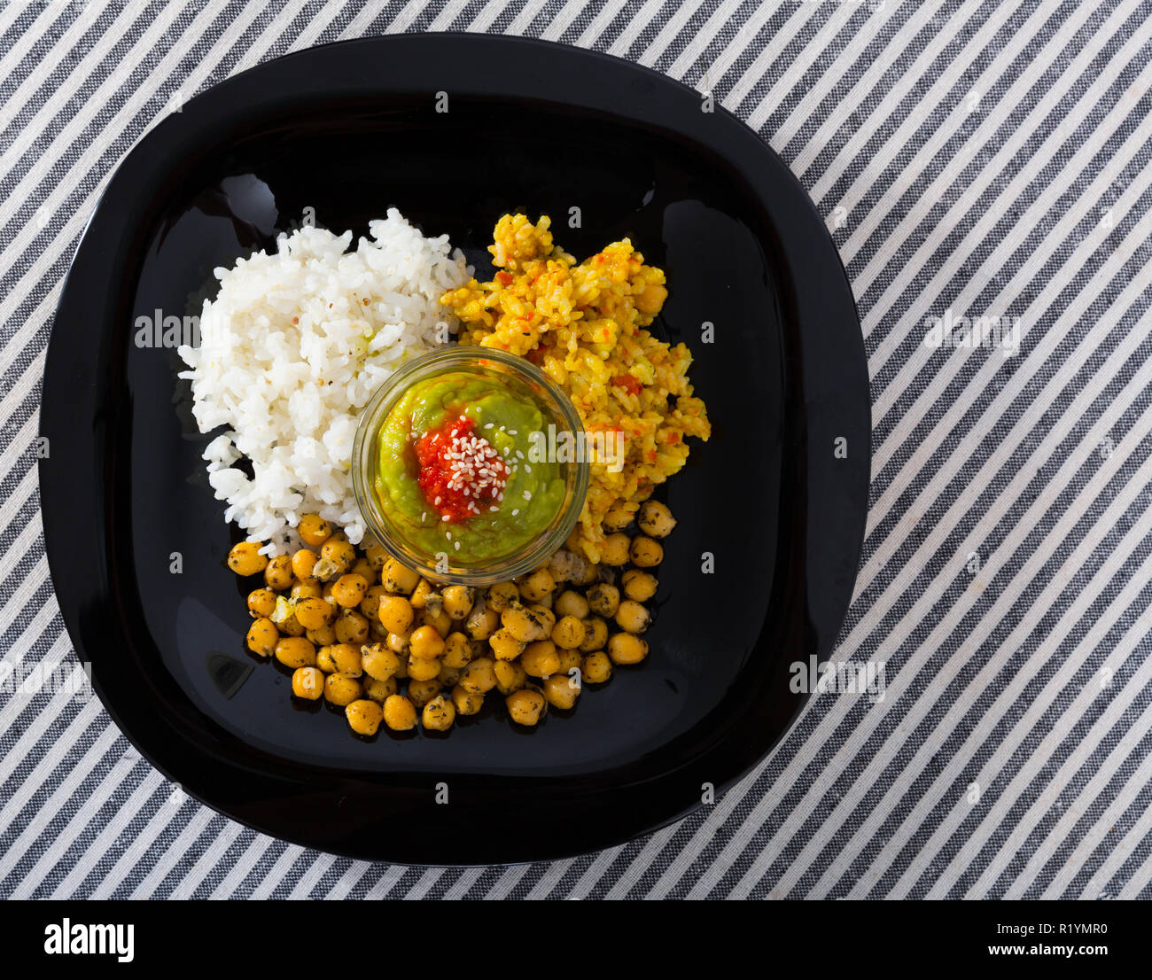 Delicious dish of chickpeas and rice with red and green sauces Stock ...