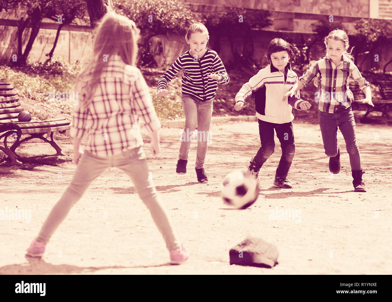 Kids playing street football hi-res stock photography and images - Alamy